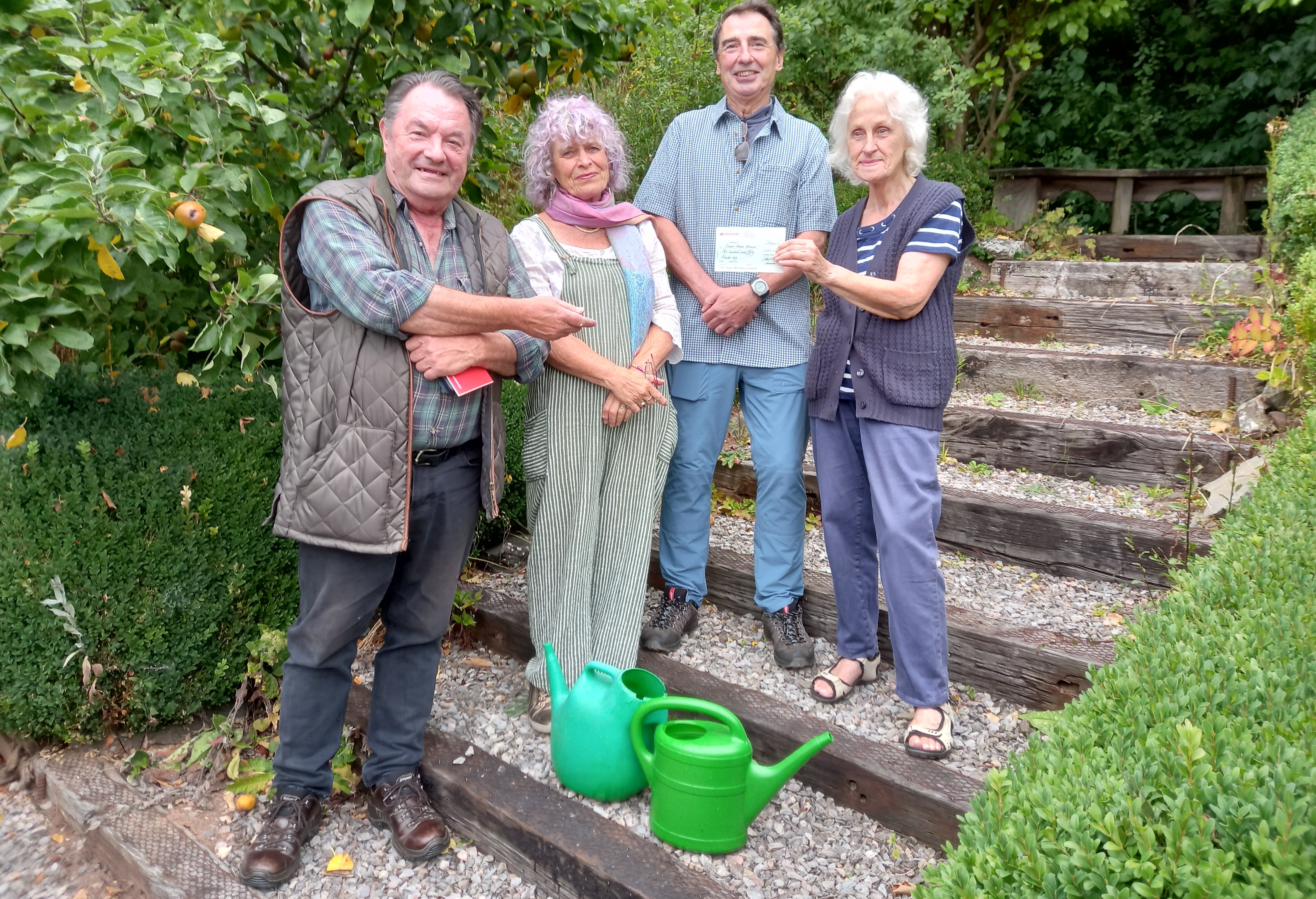 Porlock Carnival cheque handed to museum garden volunteers to help ...
